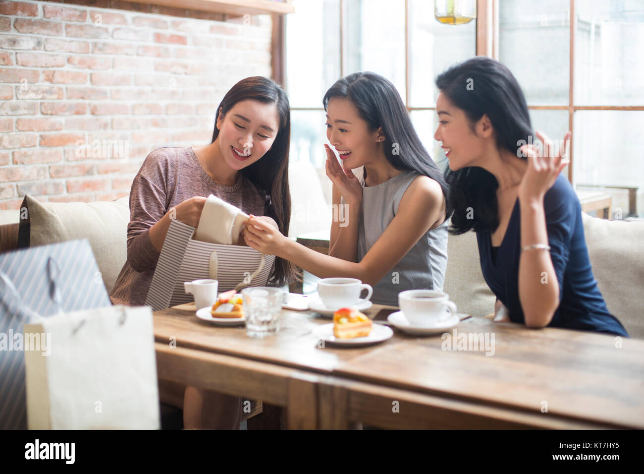 Best female friends drinking coffee in café Stock Photo - Alamy