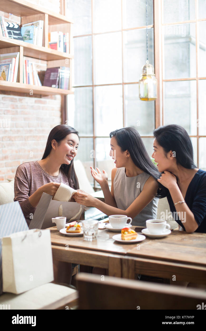 Best female friends drinking coffee in café Stock Photo - Alamy