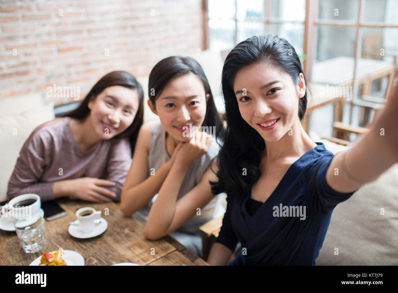 Best female friends drinking coffee in café Stock Photo - Alamy