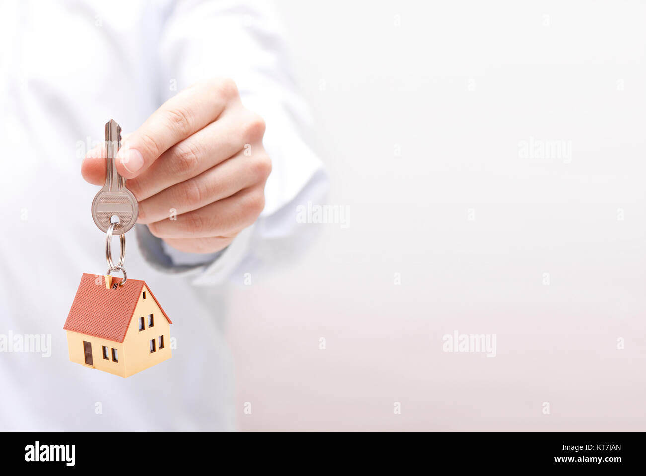 House key in hand Stock Photo - Alamy