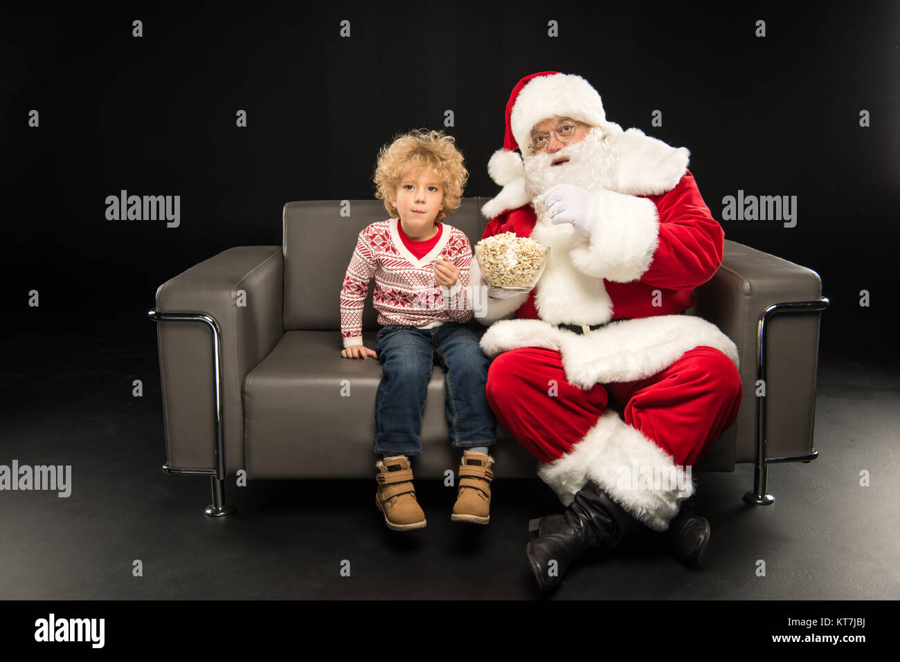 Santa Claus eating popcorn with child Stock Photo - Alamy