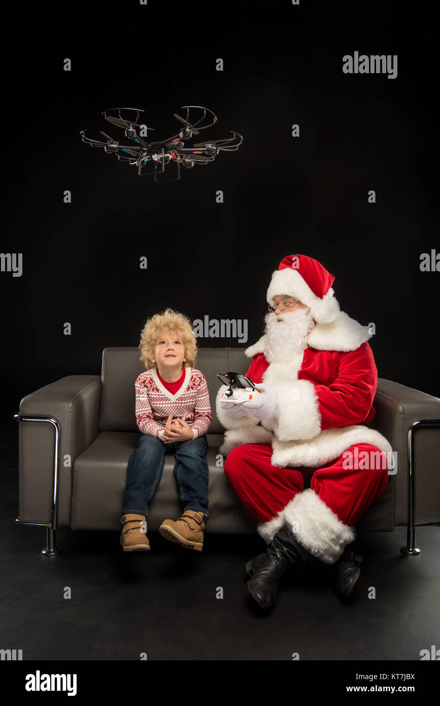 Santa Claus using hexacopter drone with child Stock Photo - Alamy