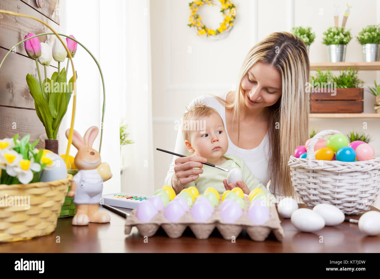 Easter concept. Happy mother and her cute child getting ready for ...