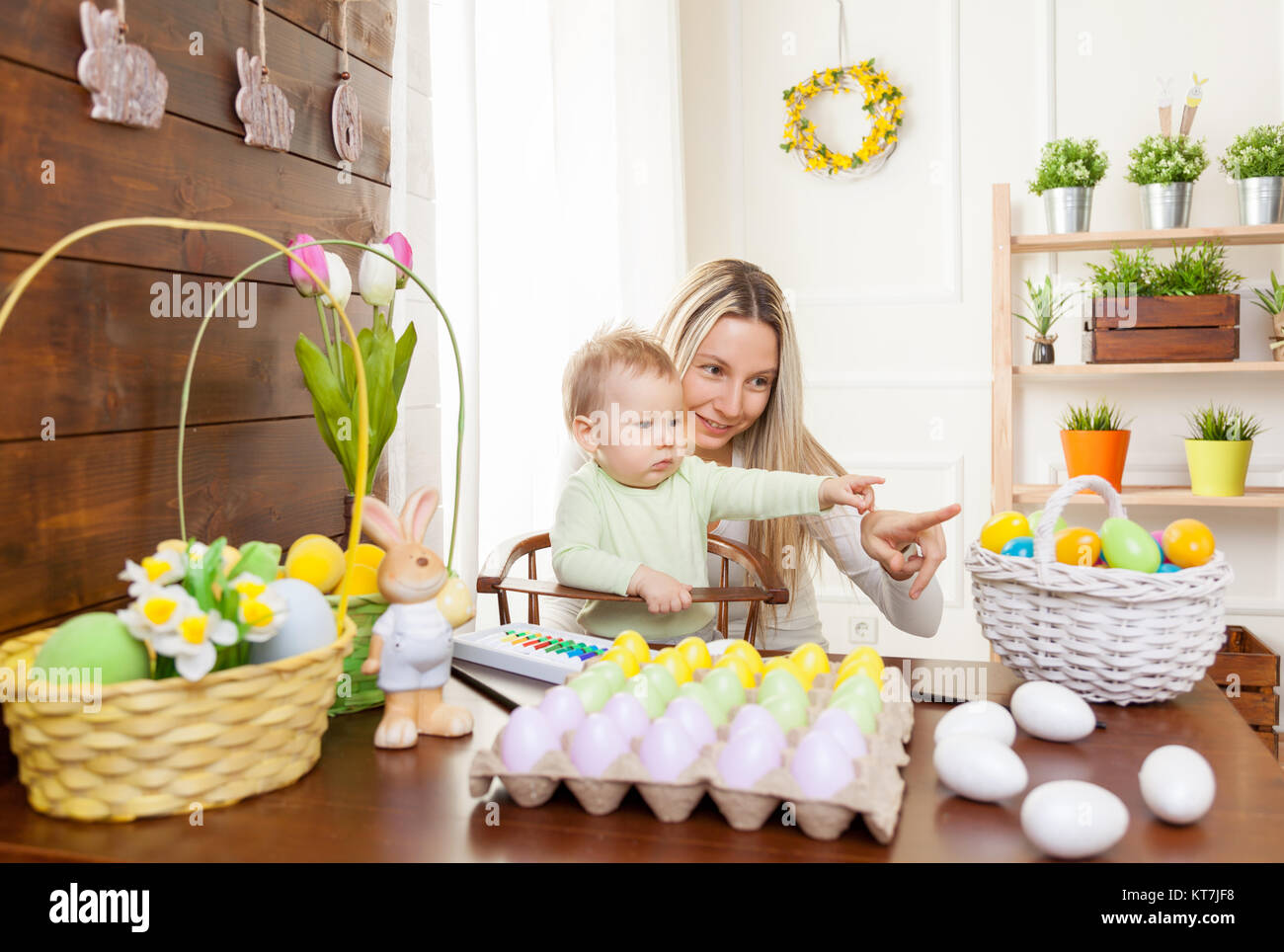 Easter concept. Happy mother and her cute child getting ready for ...
