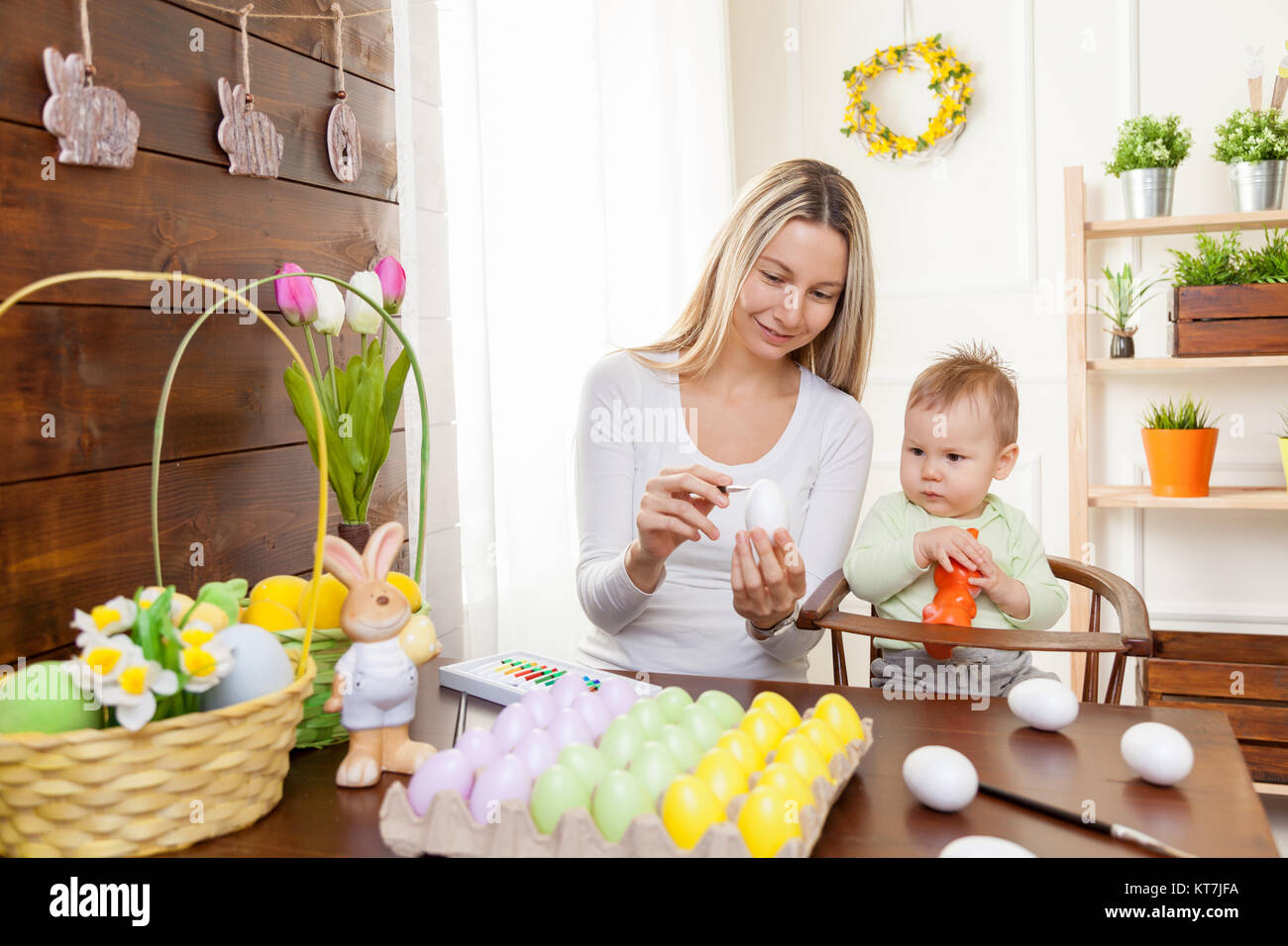 Easter concept. Happy mother and her cute child getting ready for ...