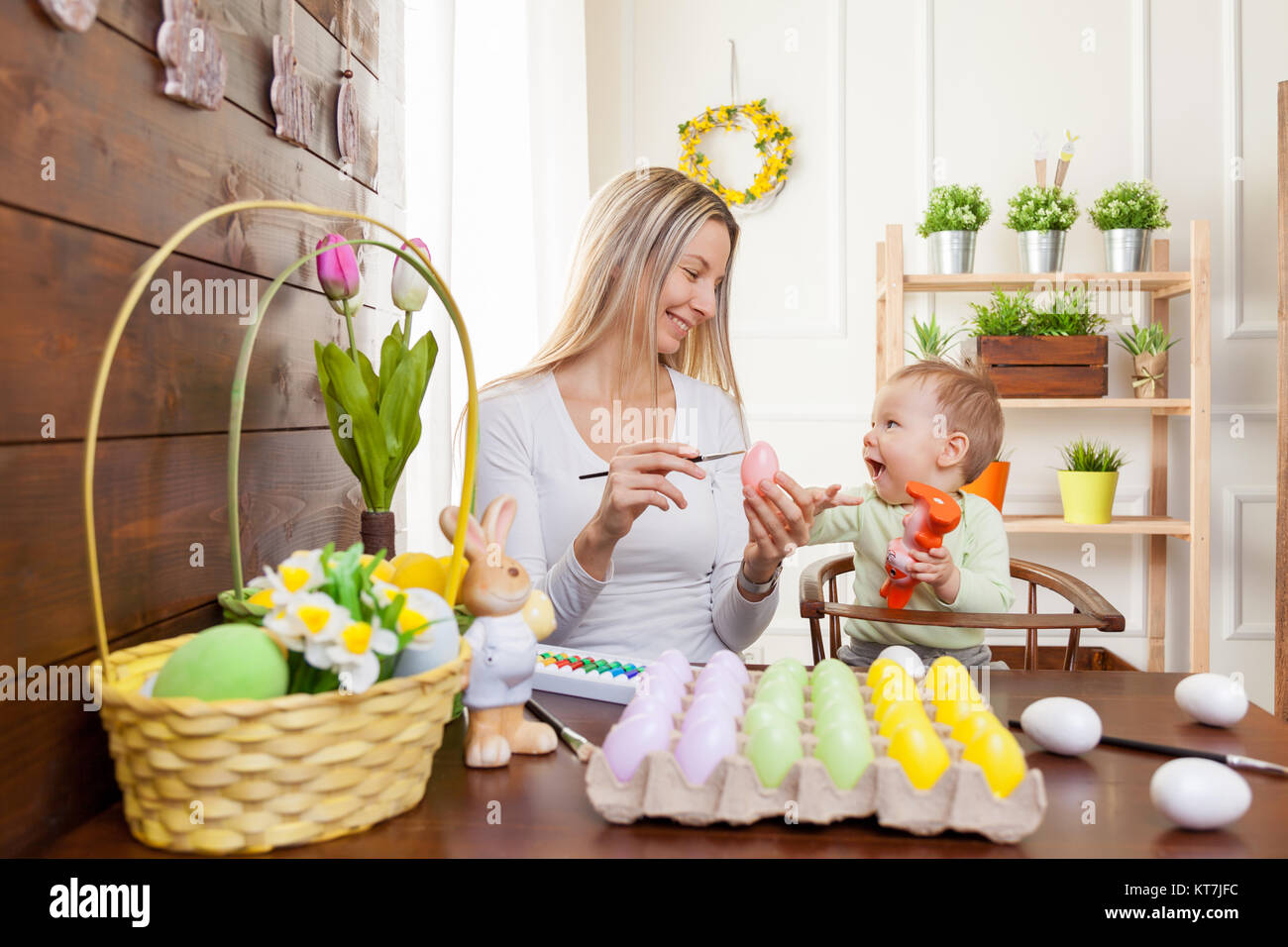 Easter concept. Happy mother and her cute child getting ready for ...