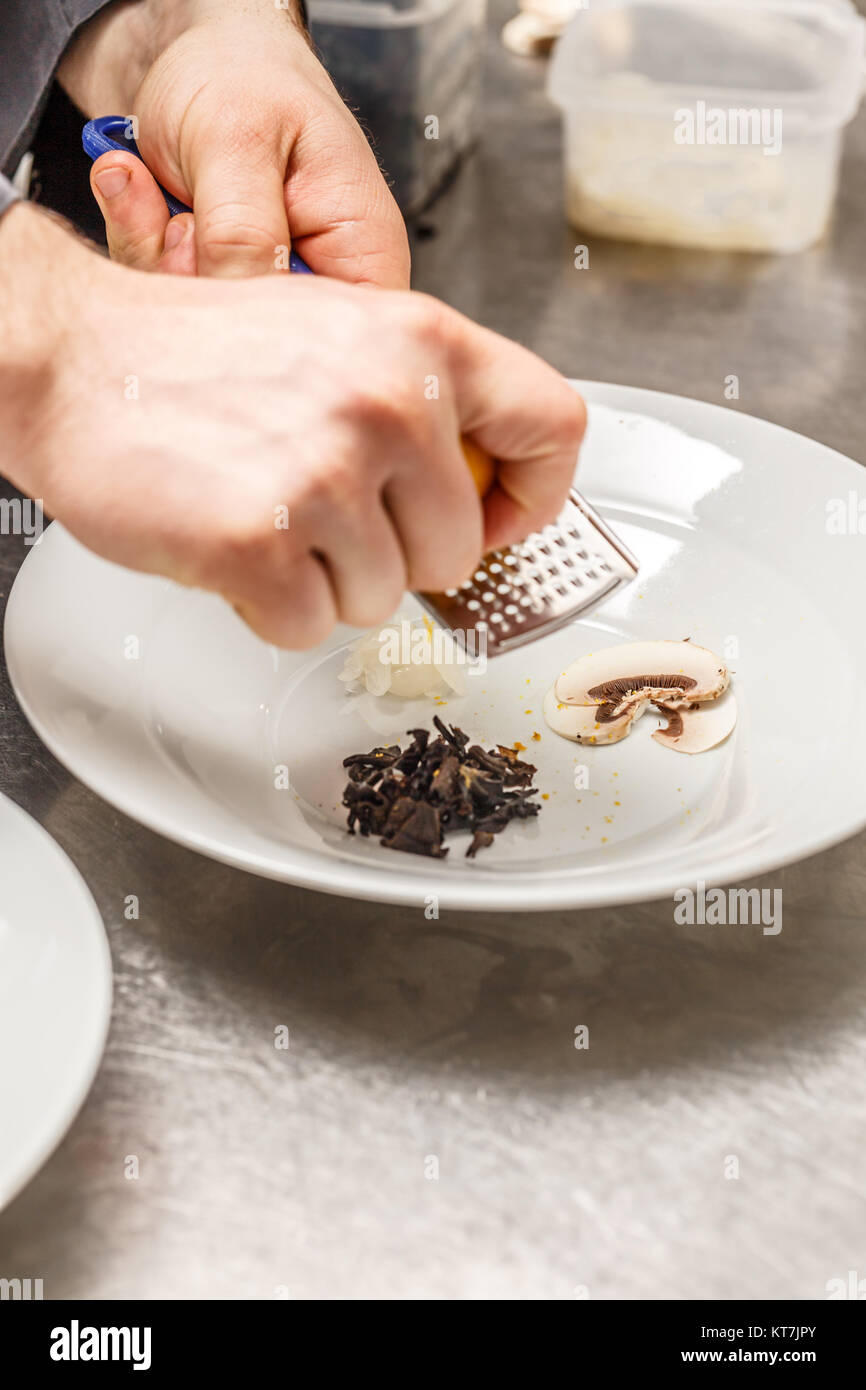 Chef rasping lemon zest Stock Photo - Alamy