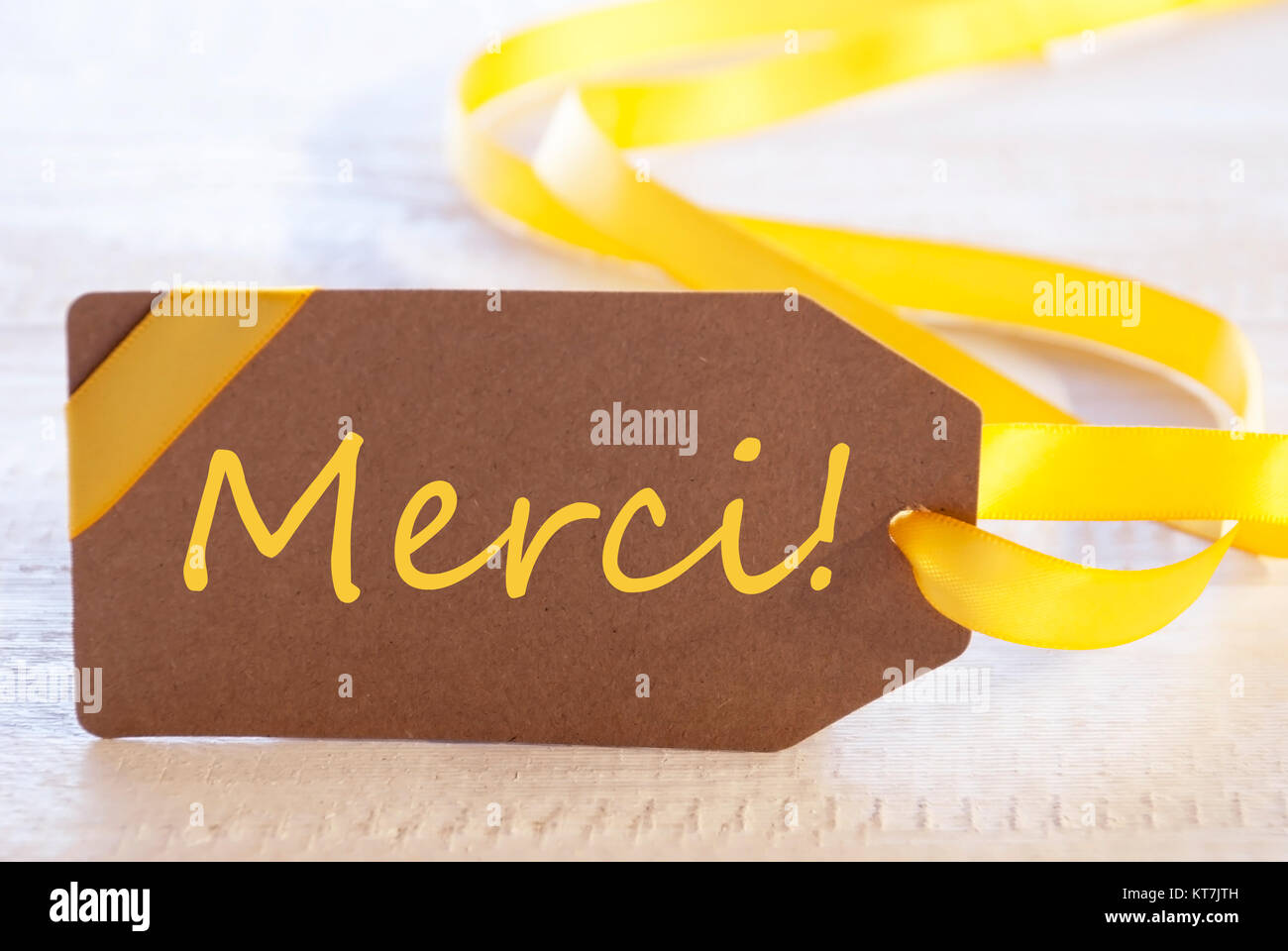 Label With French Text Merci Means Thank You. White Wooden Background ...
