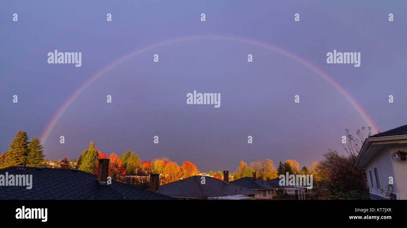 Roof top rainbow at sunset time Stock Photo - Alamy