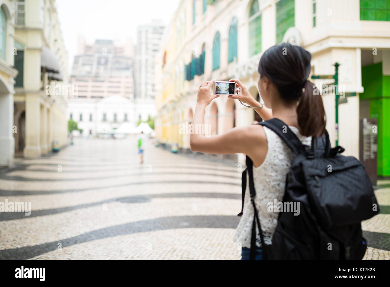 Backpacker taking photo in Macao landmark Stock Photo - Alamy