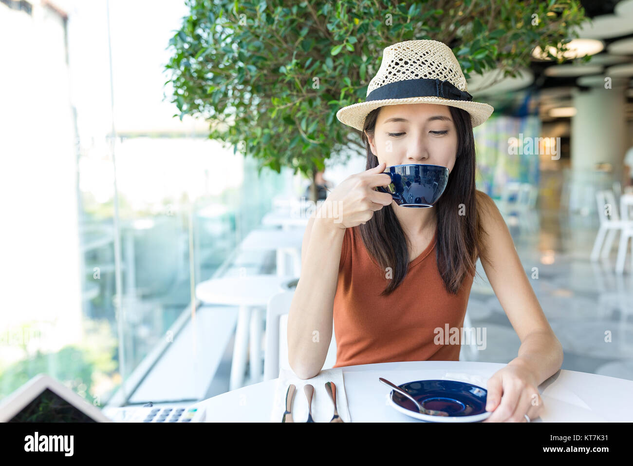 Woman enjoy coffee in cafe Stock Photo - Alamy
