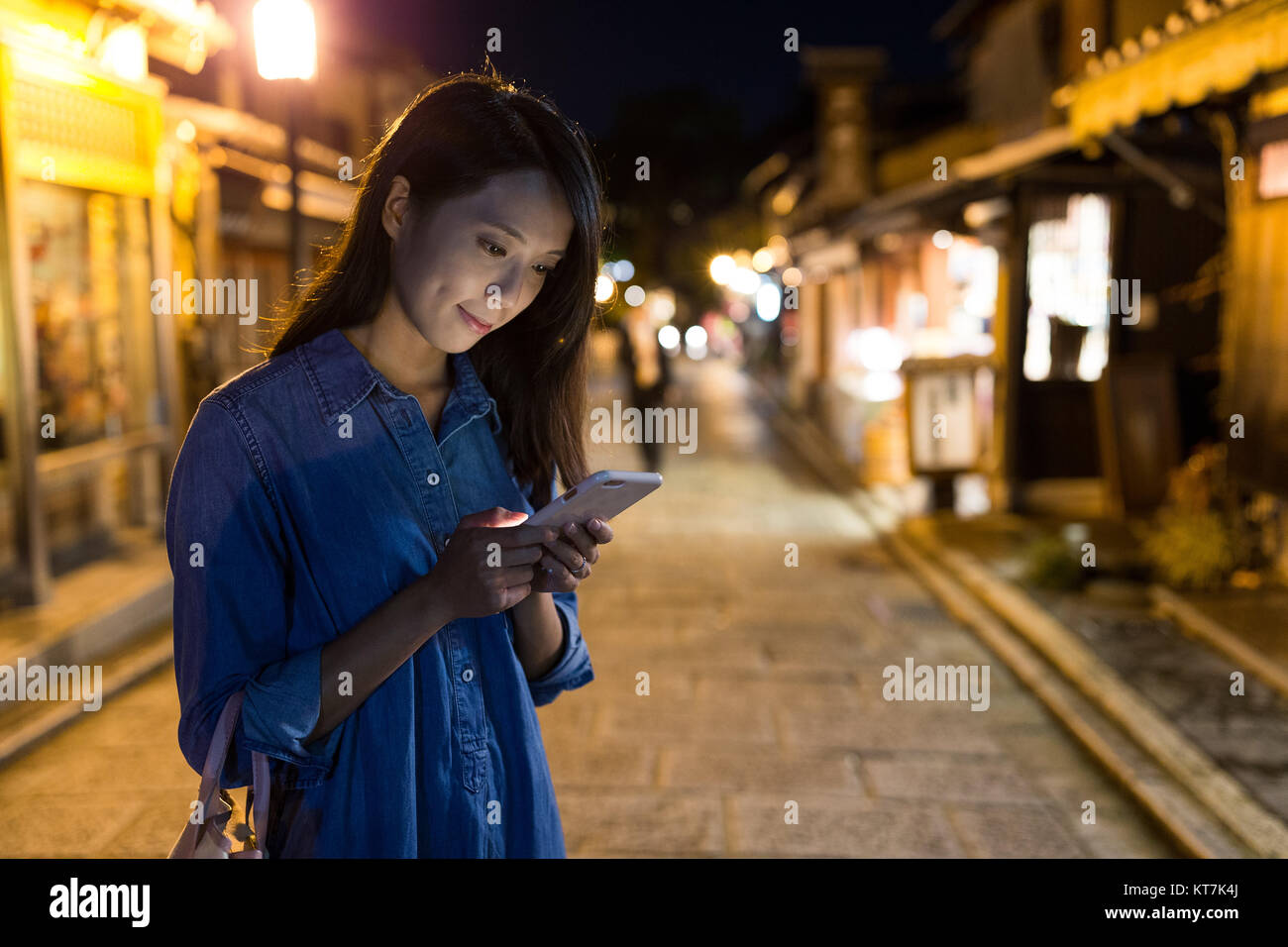 Woman using cellphone at night Stock Photo - Alamy