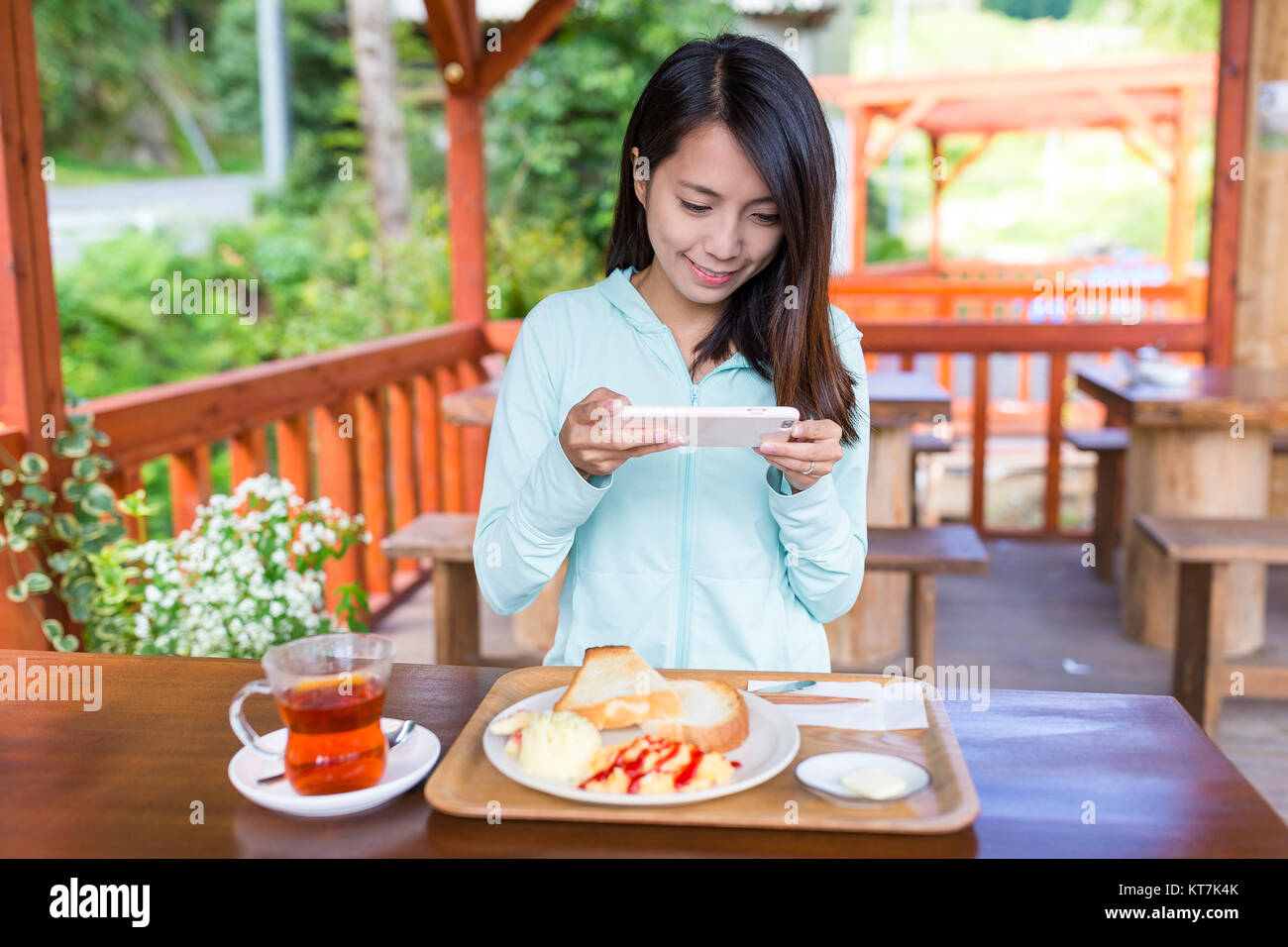 Woman taking photo on her breakfast Stock Photo - Alamy