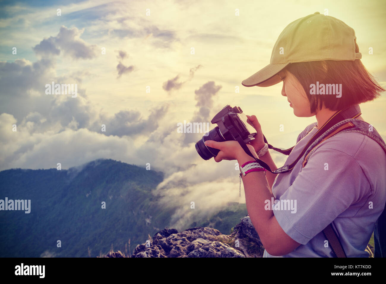 Vintage style hiker looking photo on camera Stock Photo - Alamy