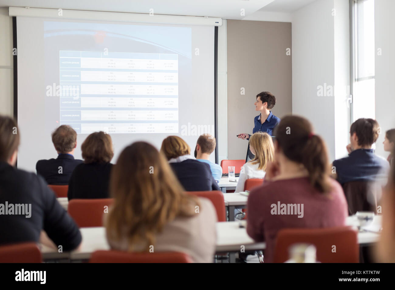 Woman giving presentation in lecture hall at university Stock Photo - Alamy