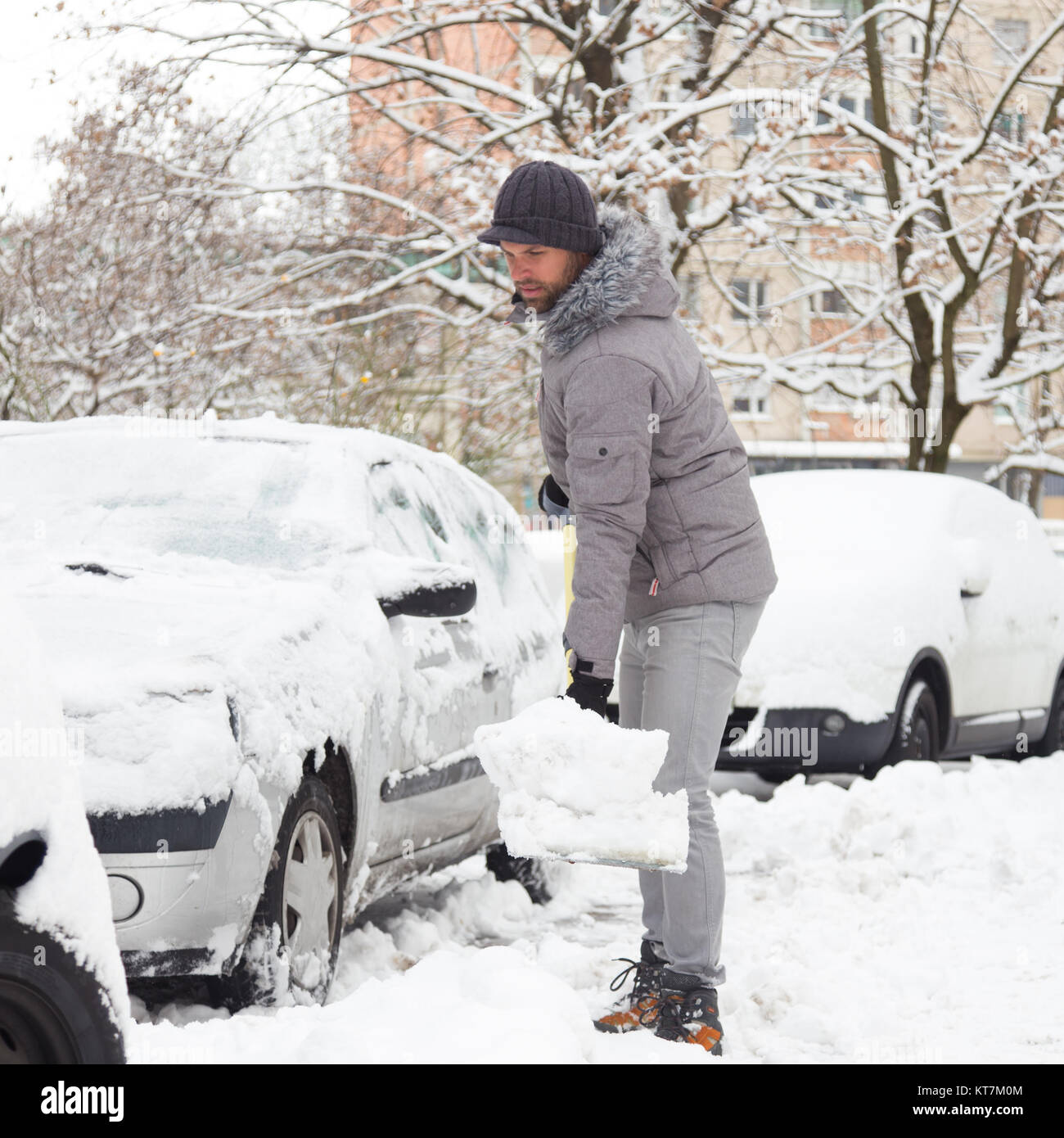 Man shoveling snow in winter Stock Photo - Alamy