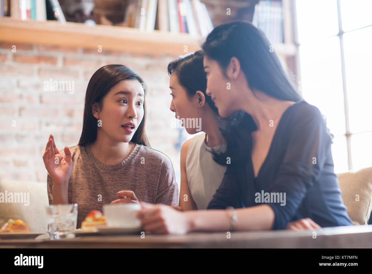 Best female friends drinking coffee in café Stock Photo - Alamy