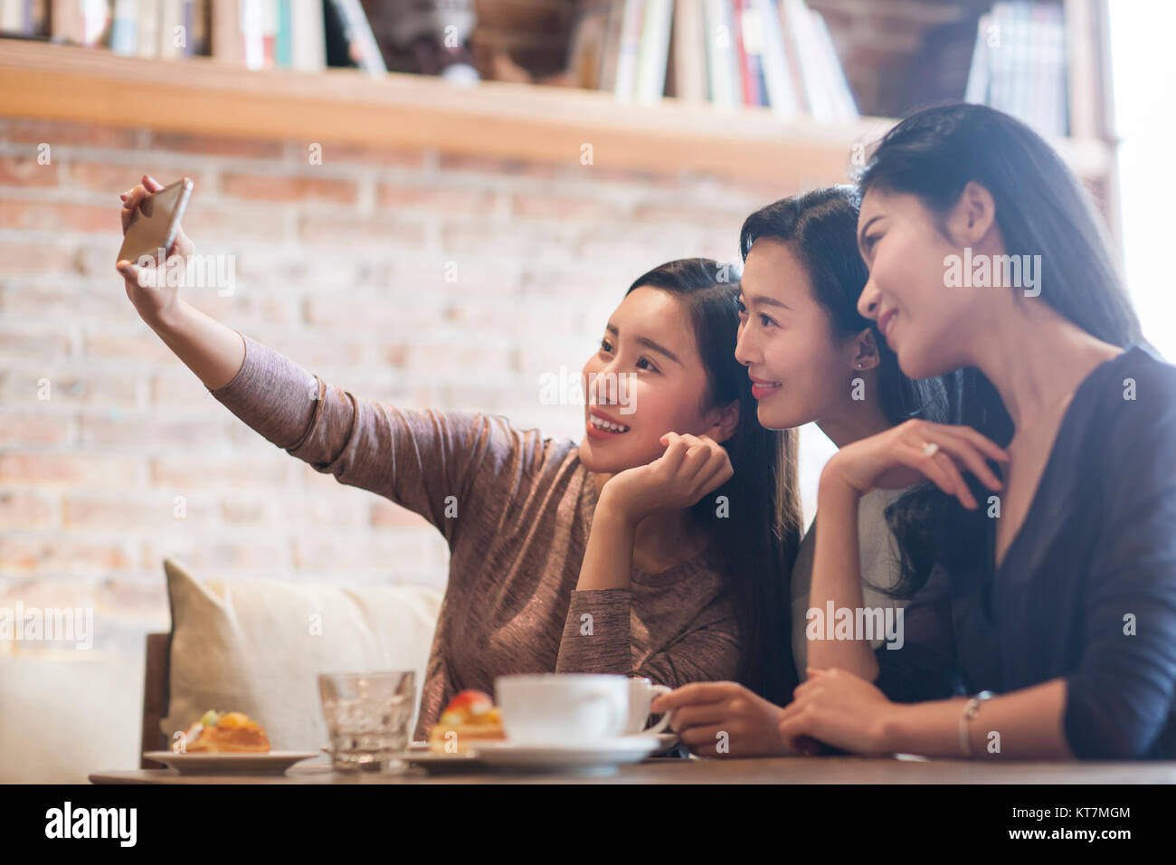 Best female friends taking self portrait with smart phone Stock Photo ...