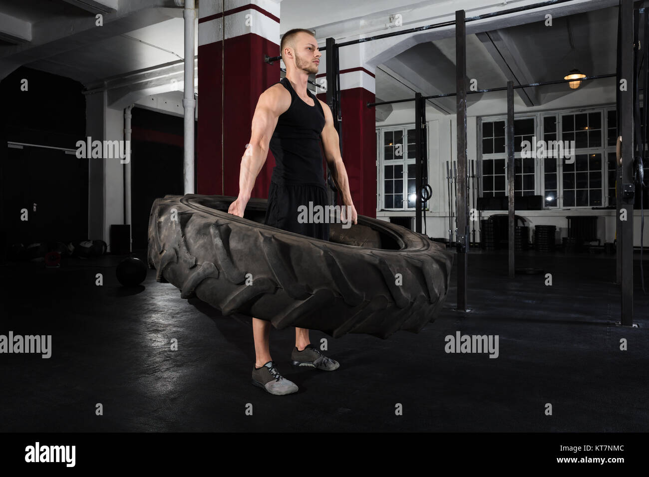 Man Doing Exercise With Tire Stock Photo - Alamy