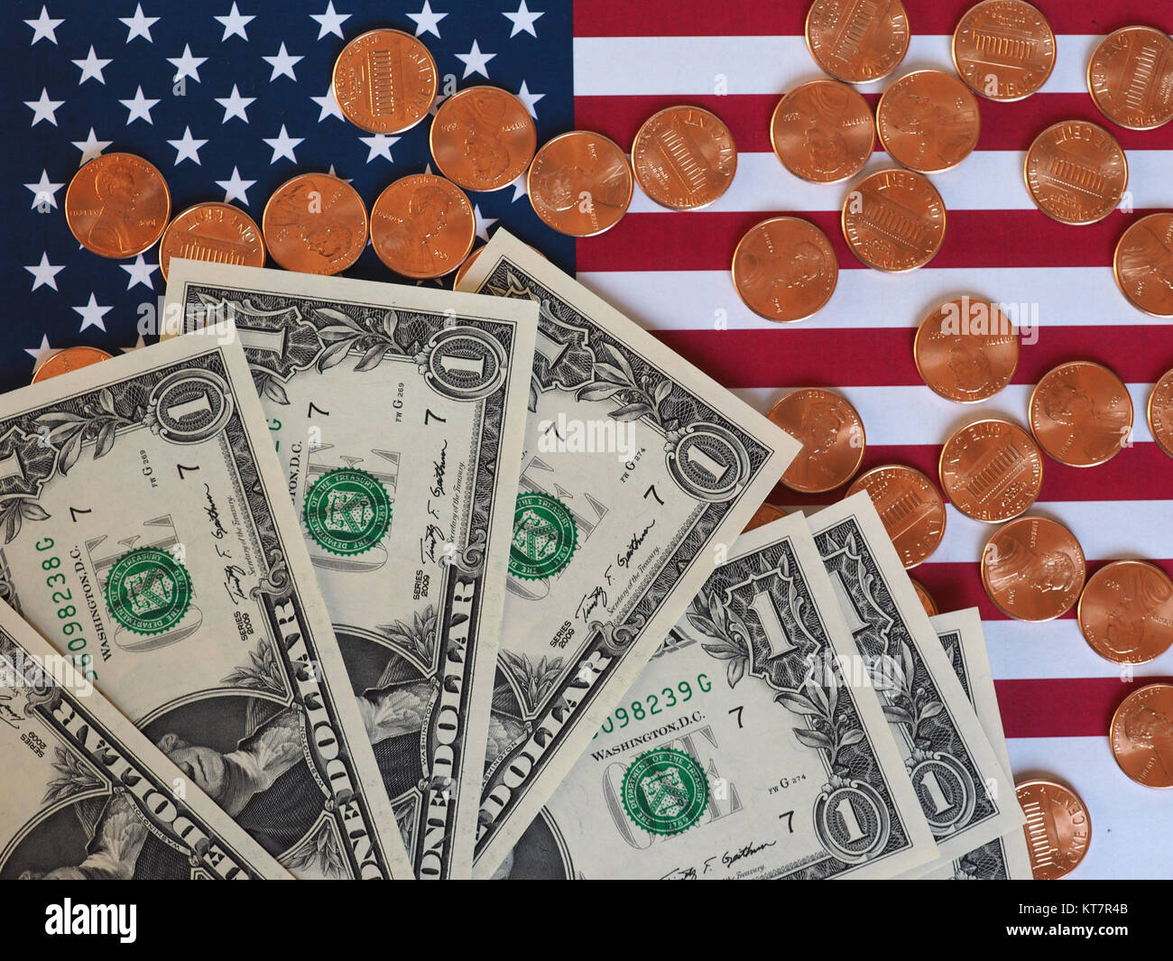 Dollar notes and coins and flag of the United States Stock Photo - Alamy