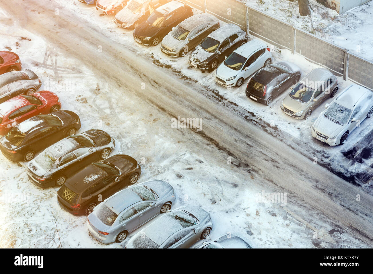 Outdoor parking full of cars covered by snow in early frosty morning ...