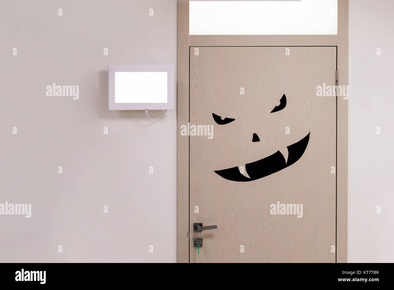 Wooden door with black angry scary monster face. Concept of doctor or ...