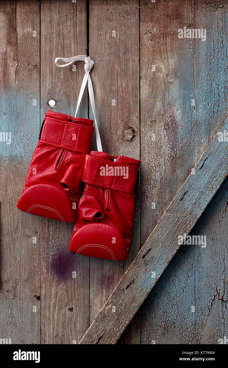 pair of red leather boxing gloves hanging on a nail Stock Photo - Alamy