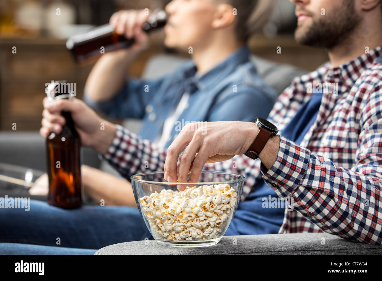 Friends eating popcorn Stock Photo - Alamy