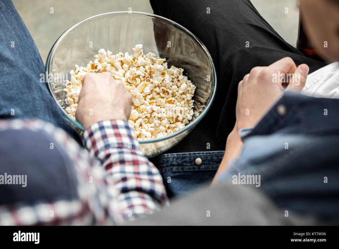 Friends eating popcorn Stock Photo - Alamy