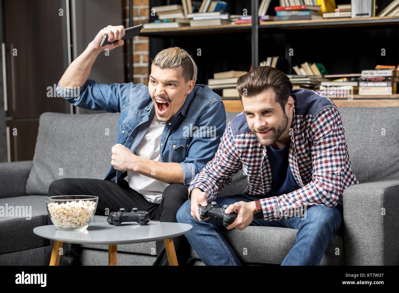 Men playing with joysticks Stock Photo - Alamy