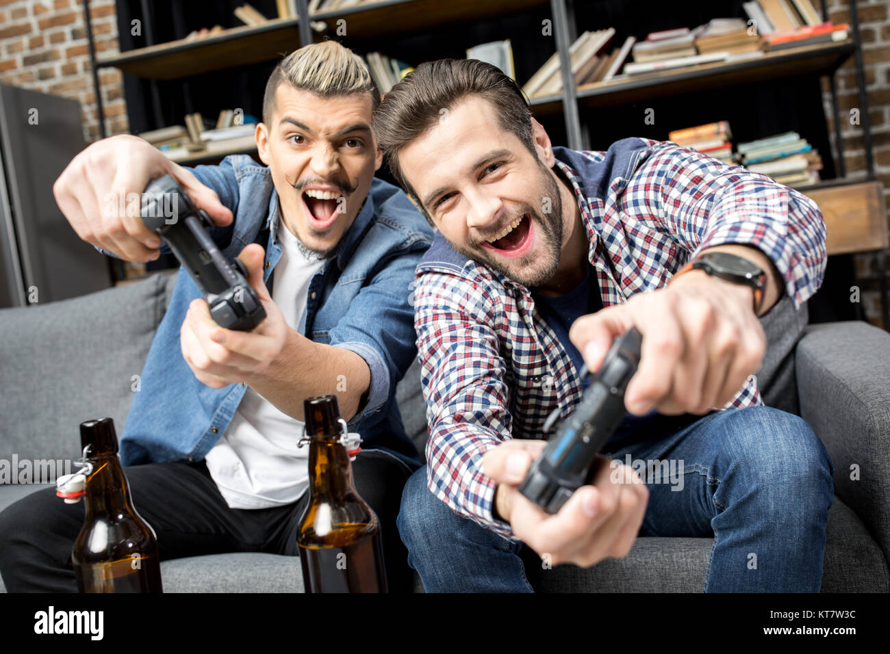 Men playing with joysticks Stock Photo - Alamy