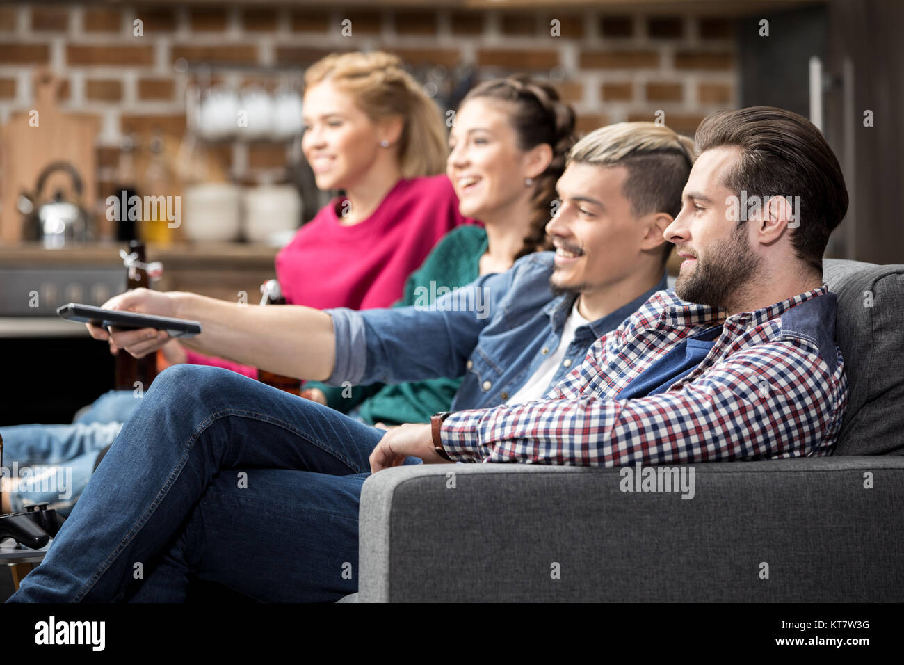 Friends watching tv Stock Photo - Alamy