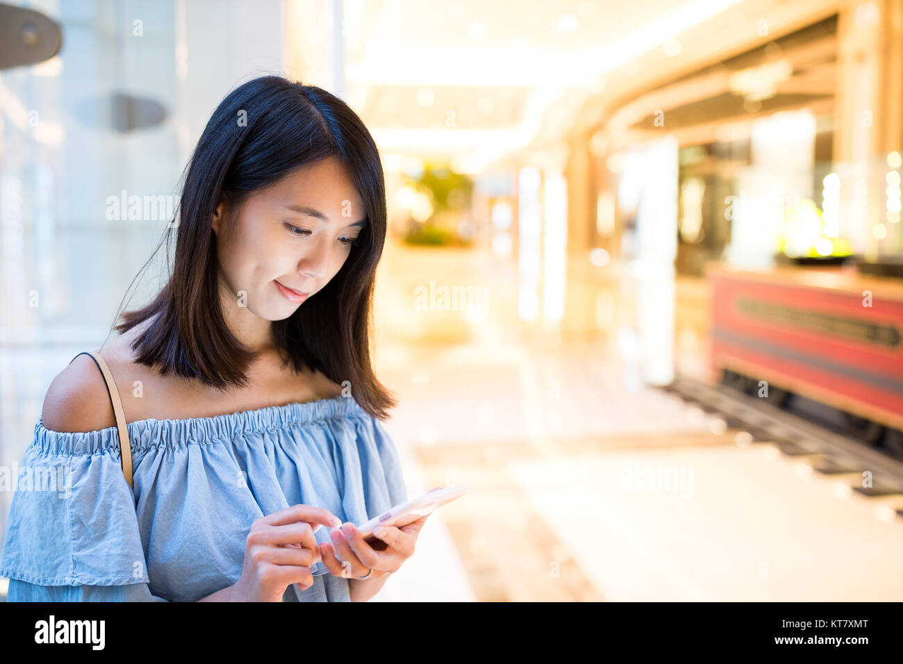 Woman use of mobile phone at shopping mall Stock Photo - Alamy