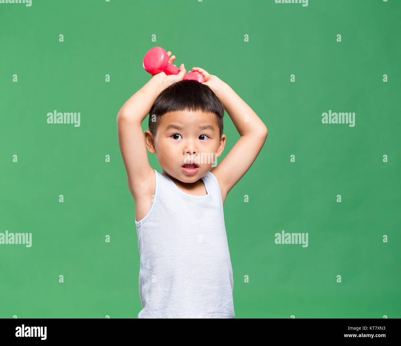 Little boy lifting up dumbbell Stock Photo - Alamy
