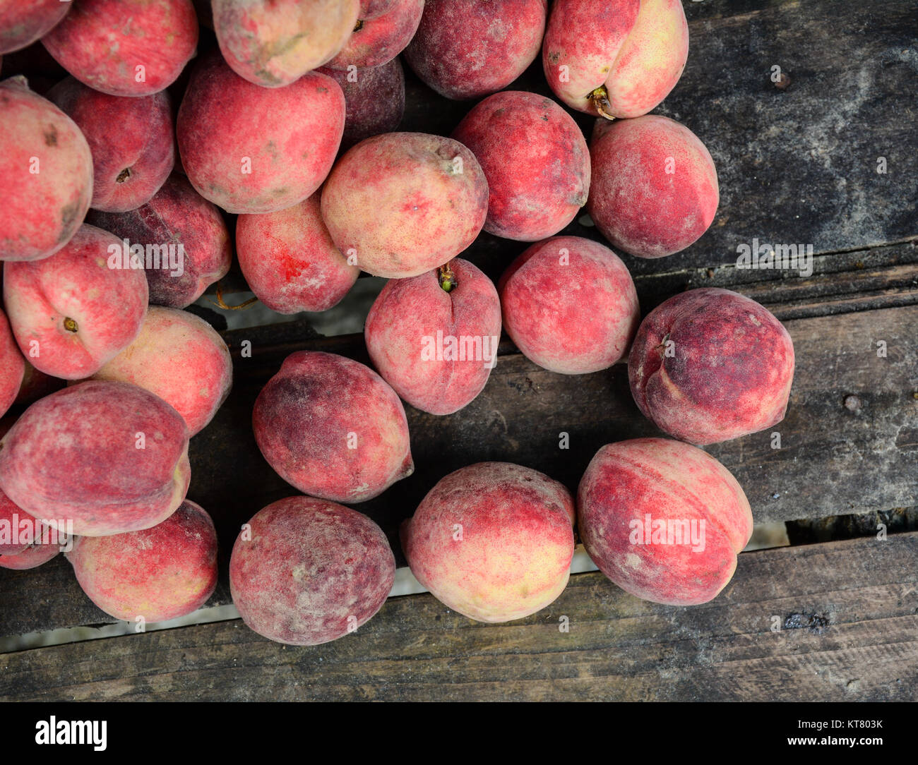Close-up of peach fruits on wooden table at the rural market in Asia ...