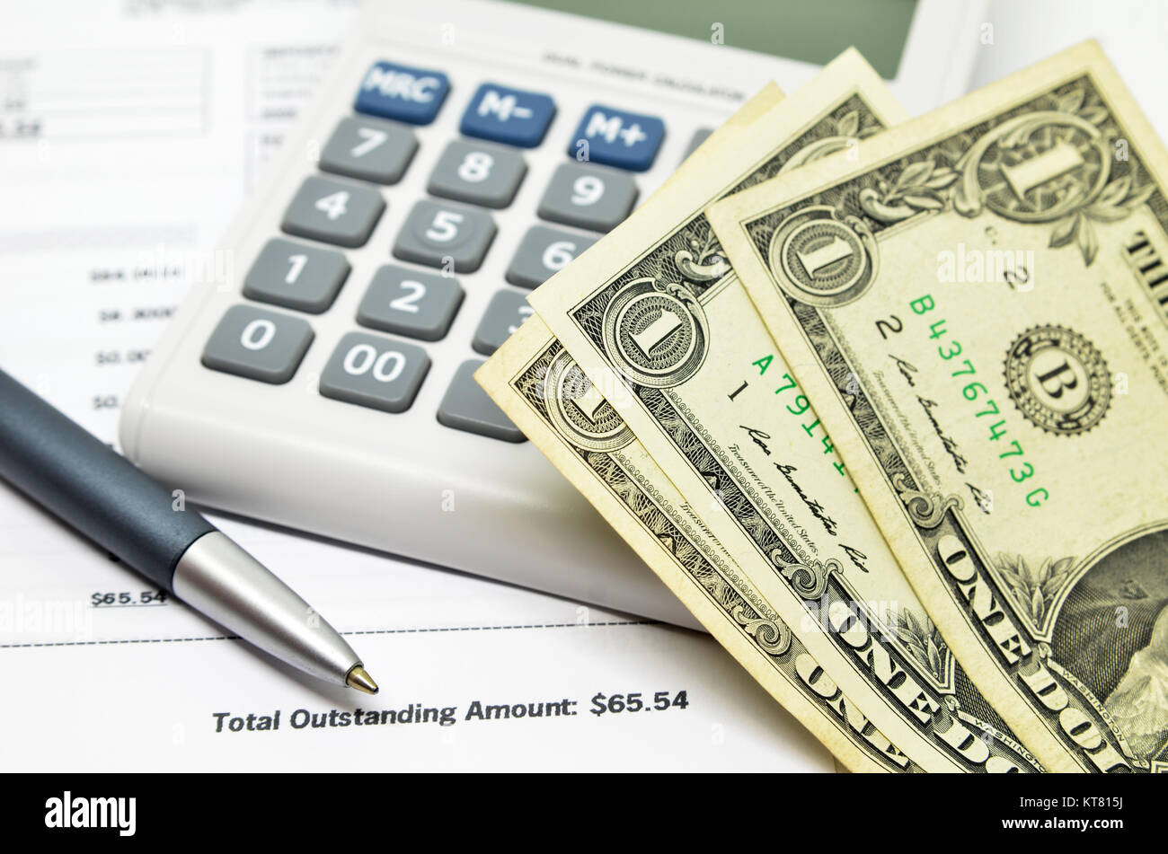 Table with money, calculator and pen Stock Photo - Alamy