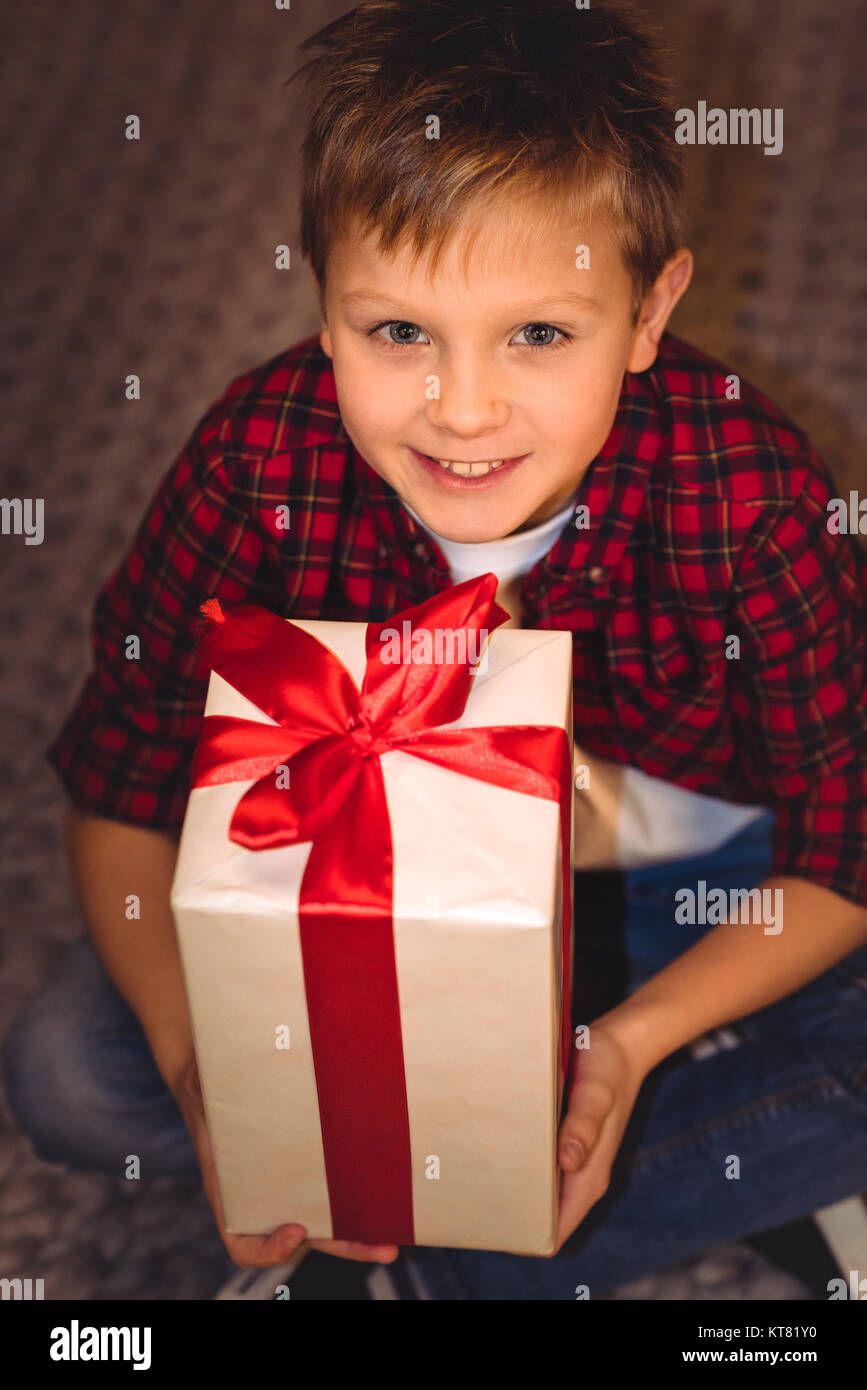 Boy holding gift box Stock Photo - Alamy