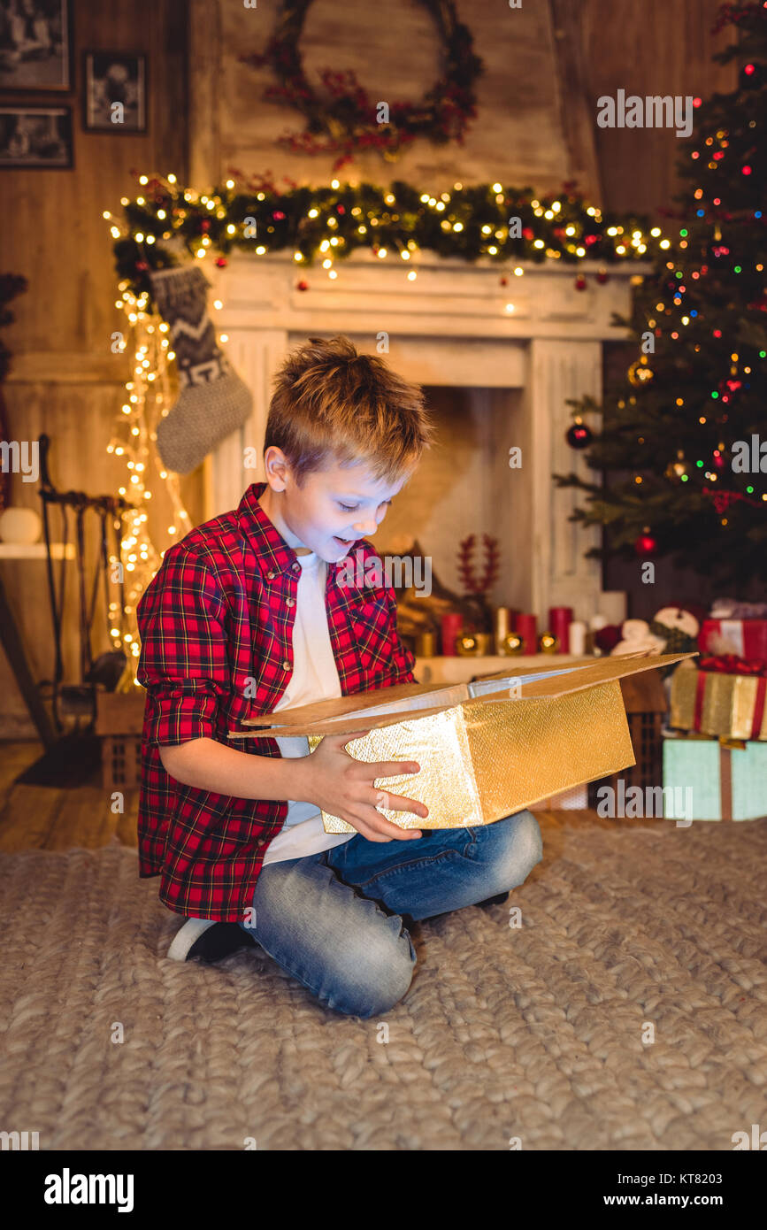 Boy opening christmas present Stock Photo - Alamy