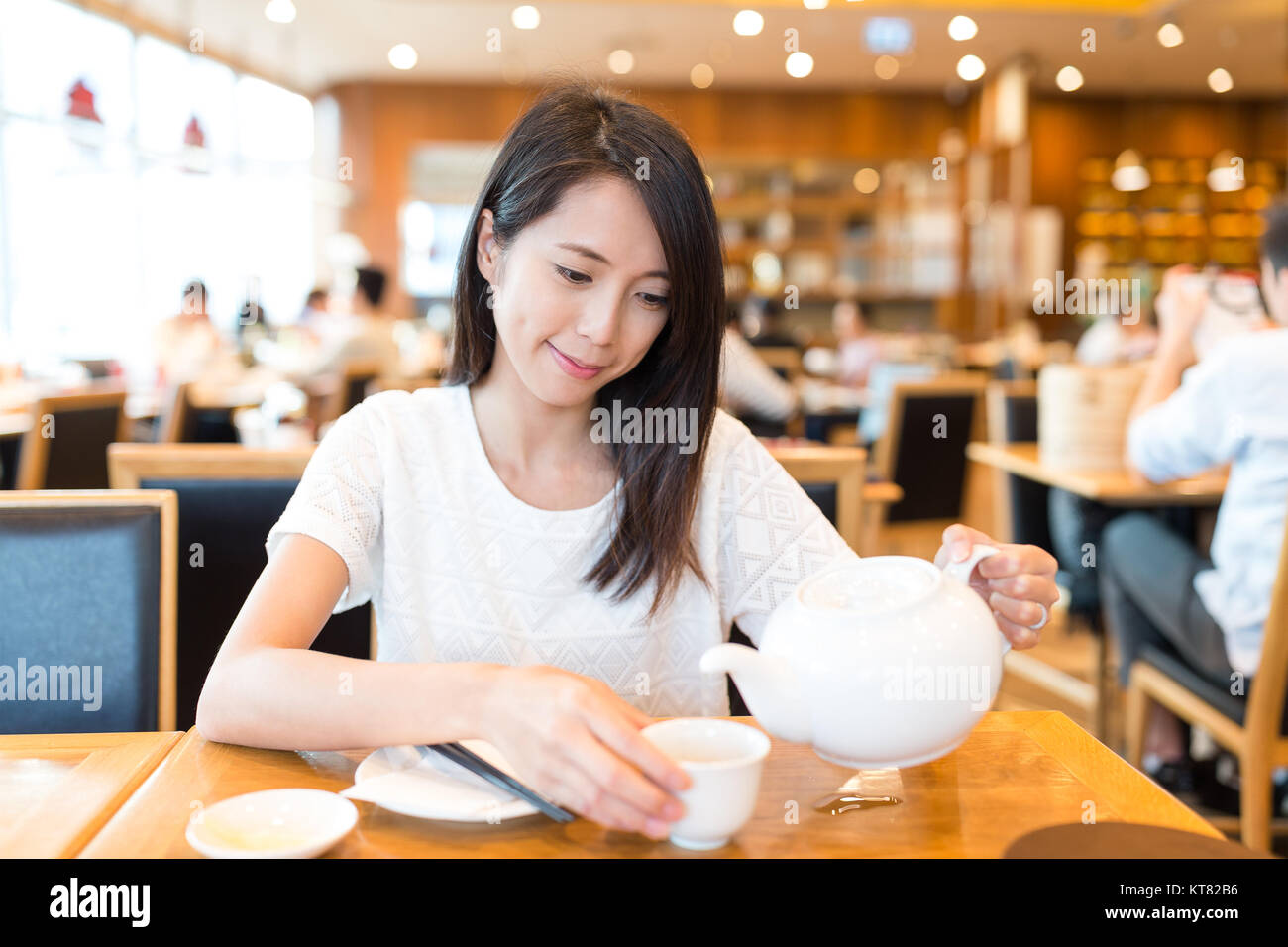 Woman enjoy her hot tea at chinese restaurant Stock Photo - Alamy