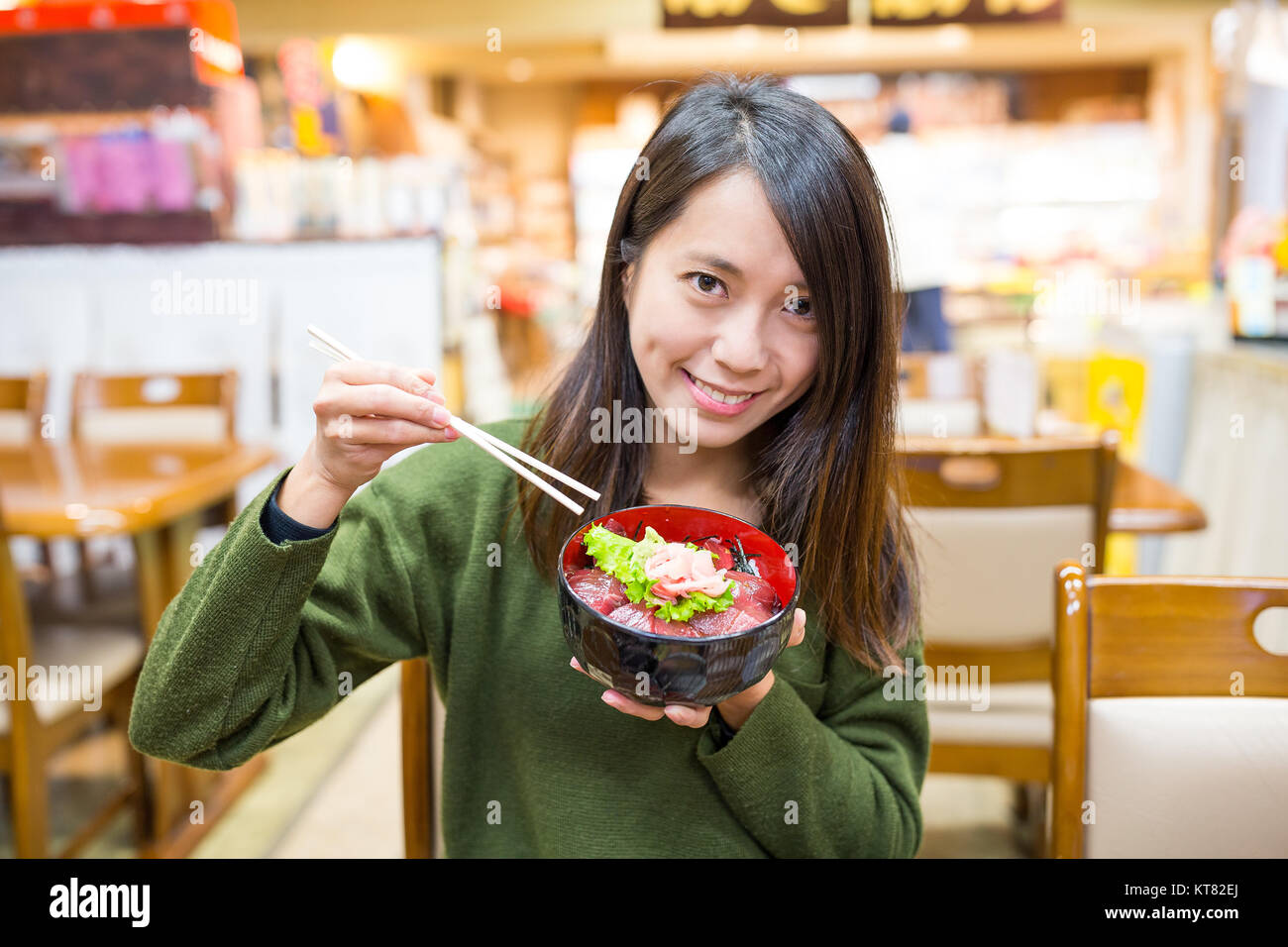 Woman eating tuna don in Japanese restaurant Stock Photo - Alamy