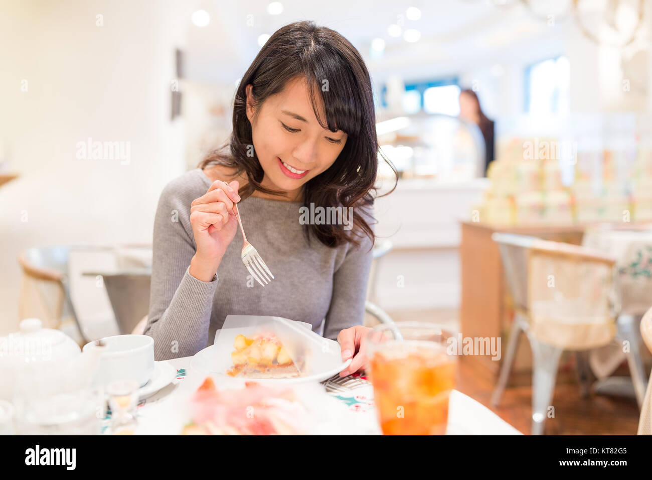 Woman enjoy her slice of cake Stock Photo - Alamy