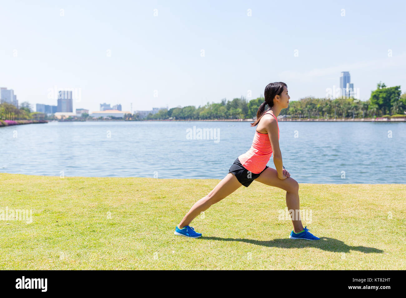 Young fitness woman runner stretching legs before run Stock Photo - Alamy