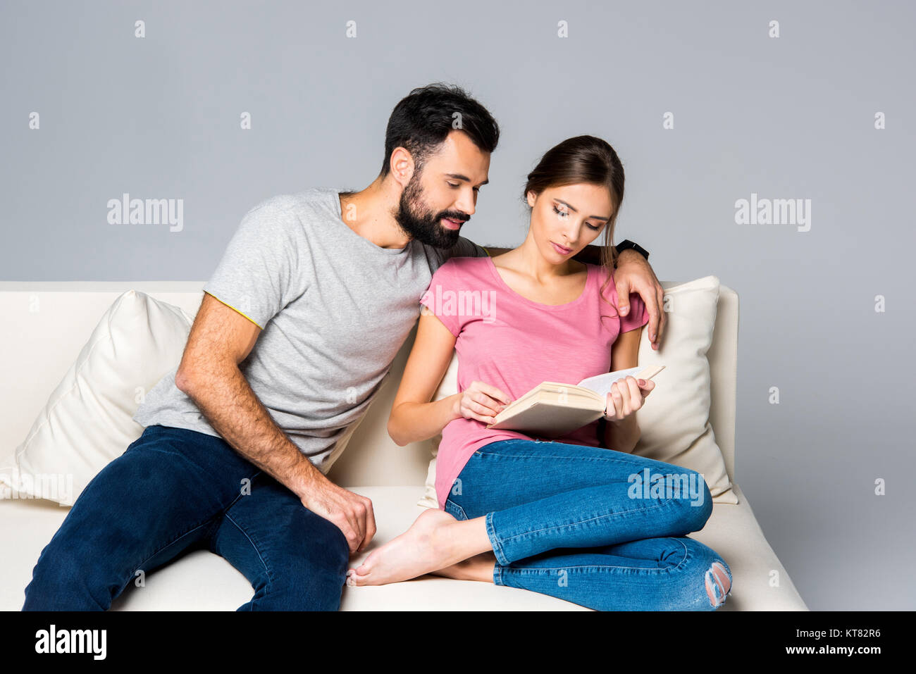 Couple reading book Stock Photo - Alamy