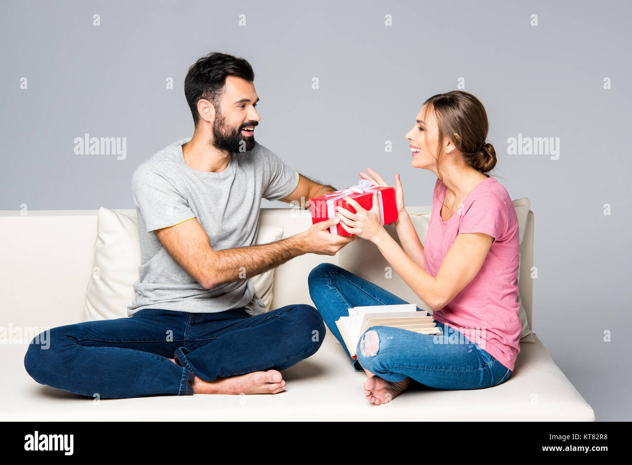 Man giving gift box to woman Stock Photo - Alamy