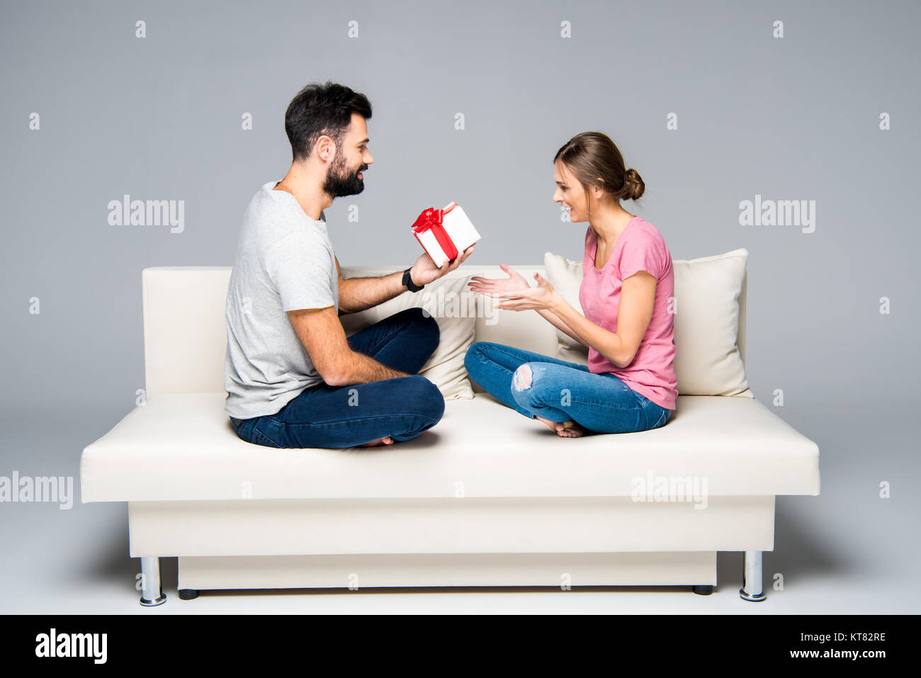 Man giving gift box to woman Stock Photo - Alamy