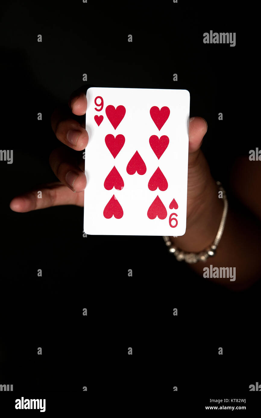 card hand holding nine of hearts gamble play Stock Photo - Alamy