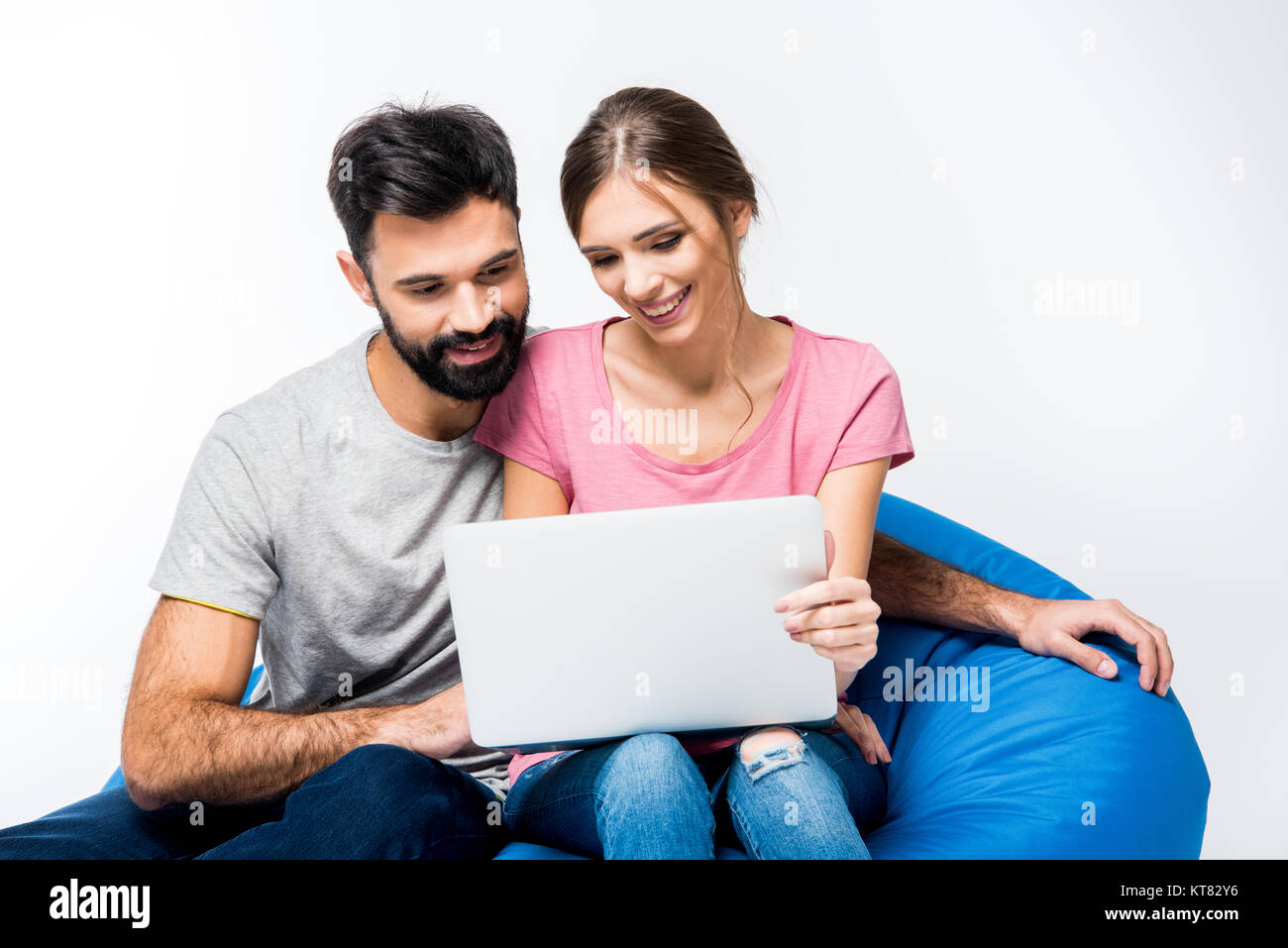 Young couple looking at laptop Stock Photo - Alamy