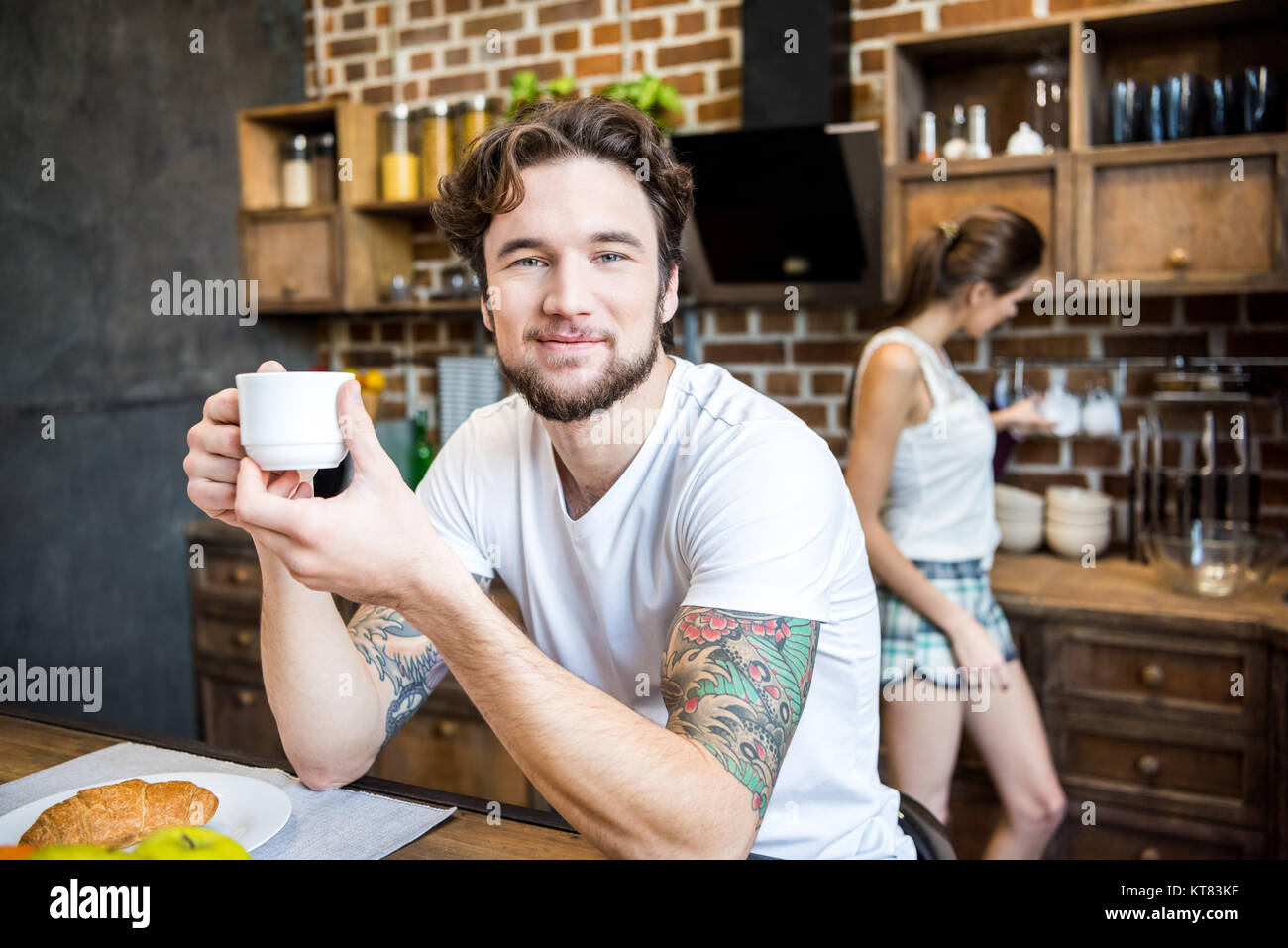 Smiling man drinking coffee Stock Photo - Alamy