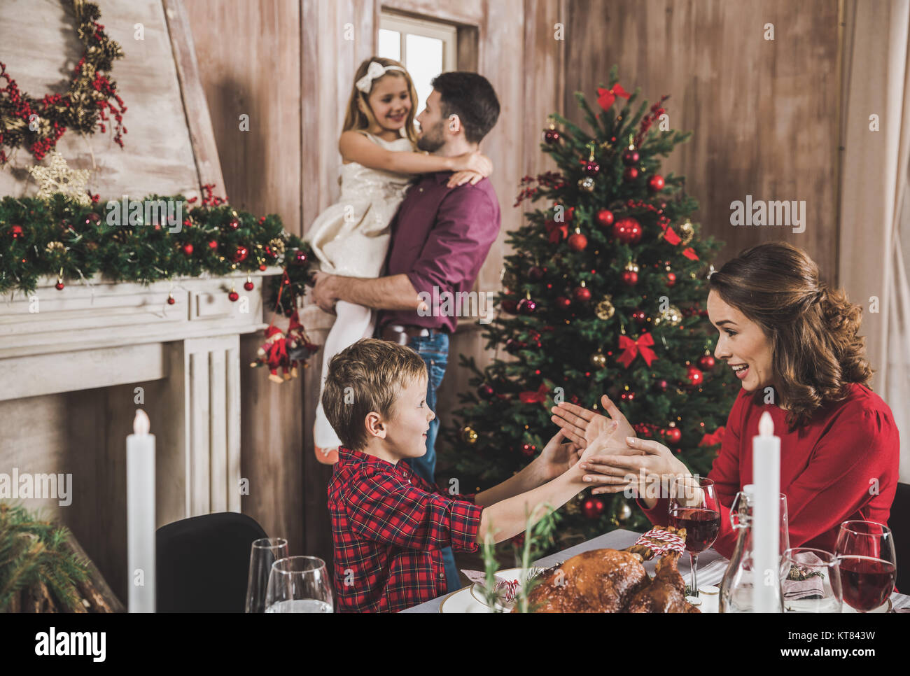 Happy family at christmastime Stock Photo - Alamy