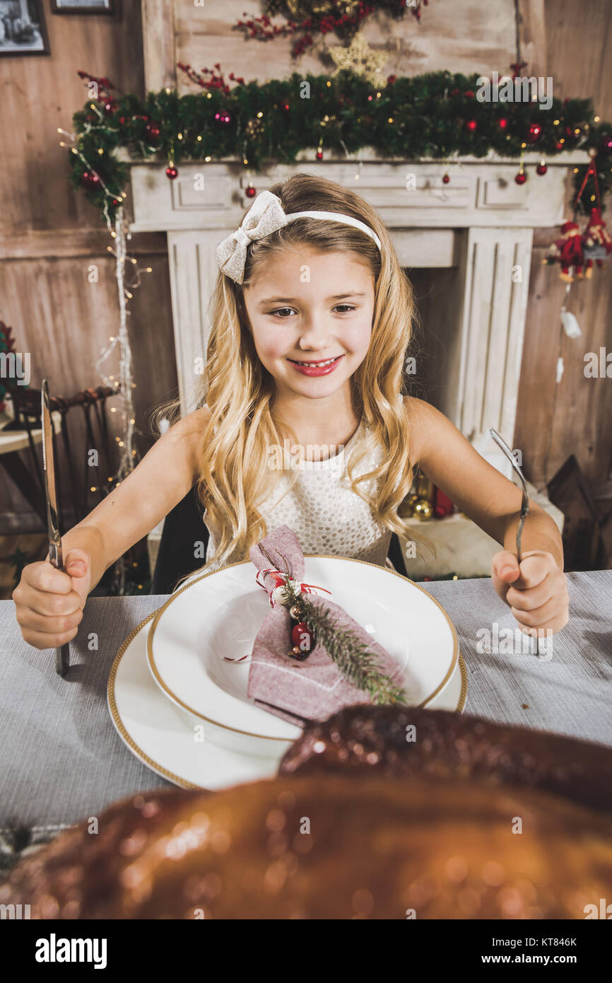 Cute girl at holiday table Stock Photo - Alamy